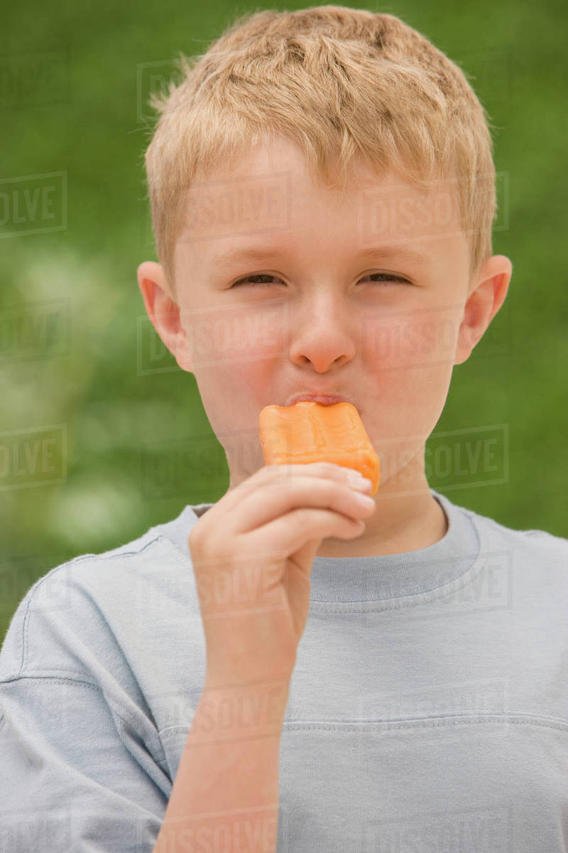 Boy eating ice pop - Stock Photo - Dissolve