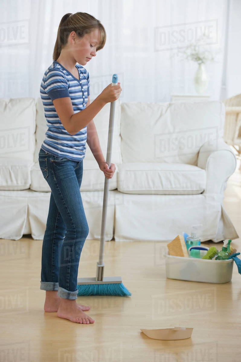 Girl cleaning livingroom - Stock Photo - Dissolve