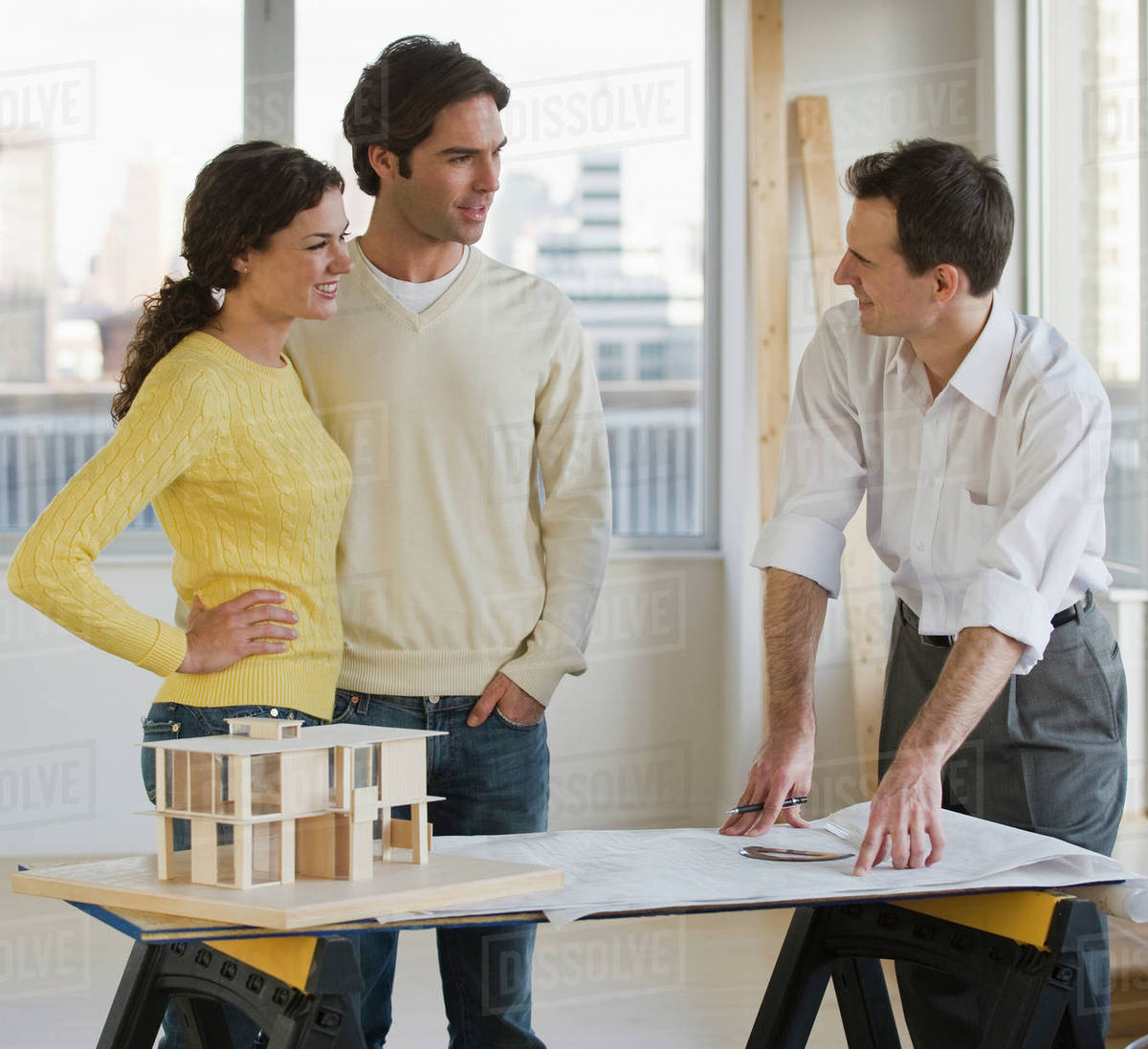 Architect presenting blueprints to couple - Royalty-free Stock Photo ...