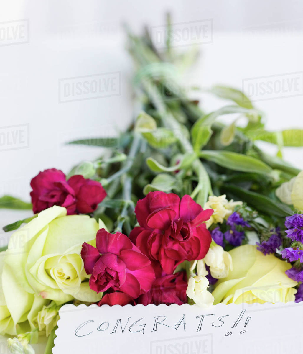 Close up of flower bouquet and note - Stock Photo - Dissolve