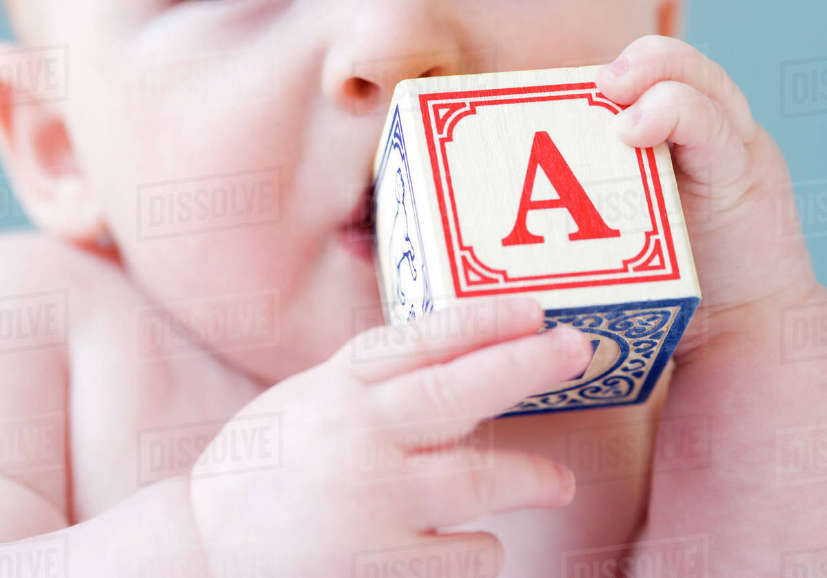 Close up of baby biting on alphabet block - Royalty-free Stock Photo ...