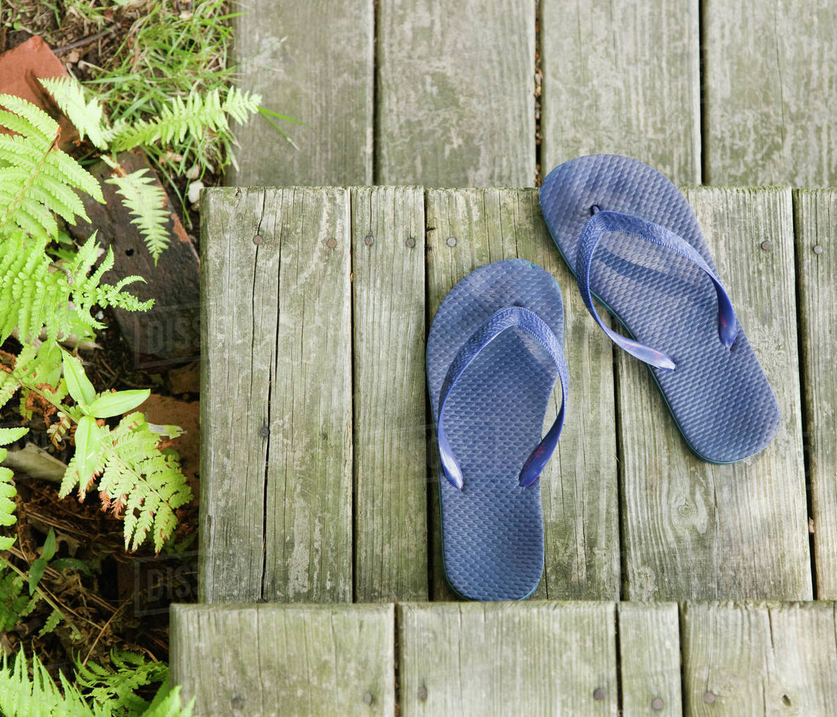 Flip-flops on wooden deck - Royalty-free Stock Photo | Dissolve