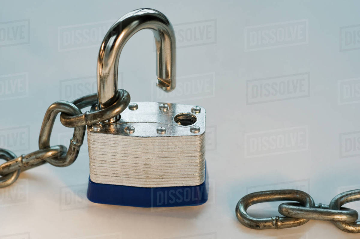 Close up of lock and metal chain - Royalty-free Stock Photo | Dissolve