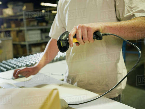 Warehouse worker scanning package - Royalty-free Stock Photo | Dissolve