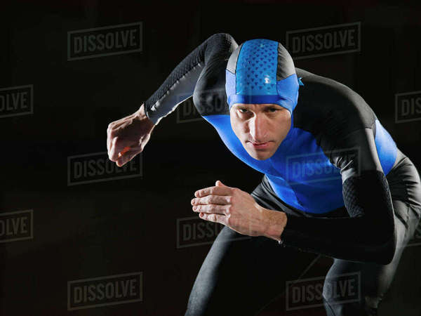 Male speed skater in ready position - Stock Photo - Dissolve