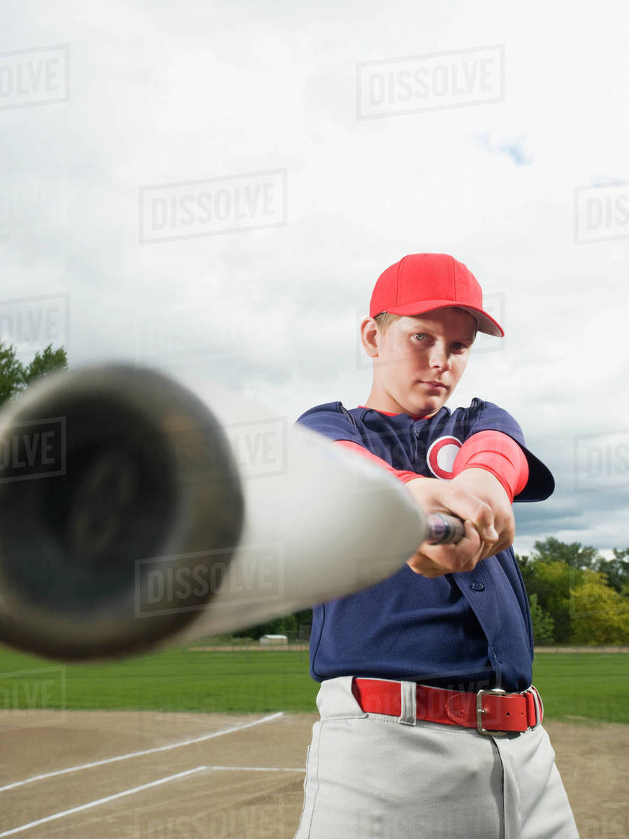 Baseball player swinging bat - Stock Photo - Dissolve