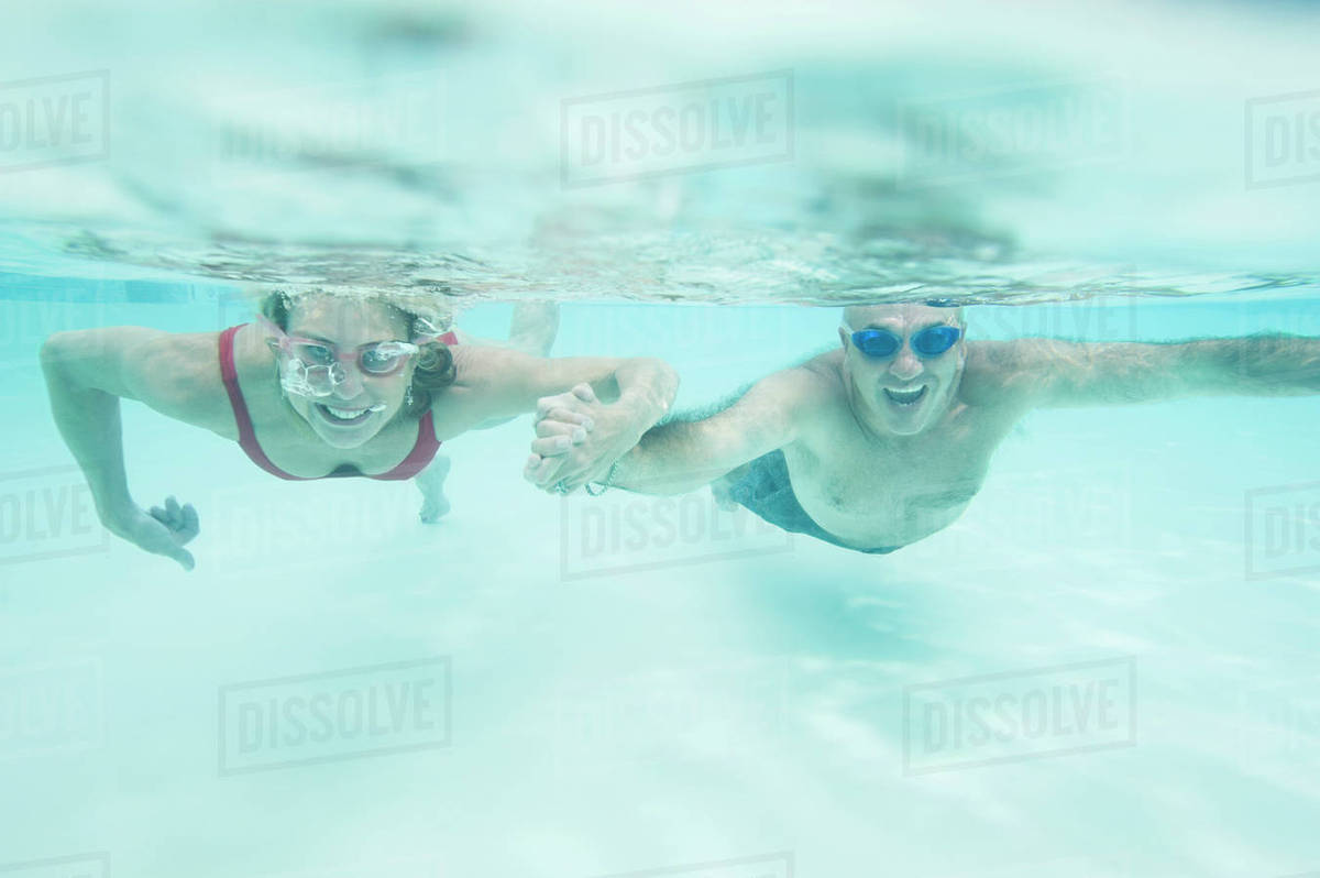 Couple swimming underwater and holding hands - Royalty-free Stock Photo ...