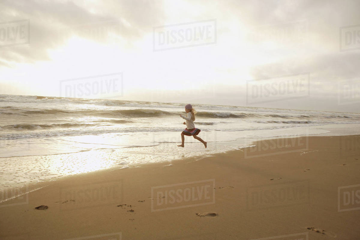 Girl running on beach - Royalty-free Stock Photo | Dissolve