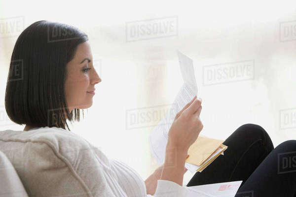 Woman reading mail - Stock Photo - Dissolve