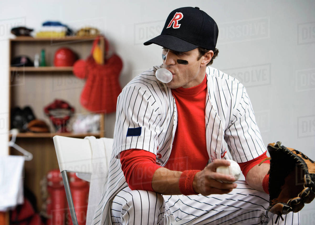 Baseball player blowing bubble with gum in locker room - Royalty-free ...