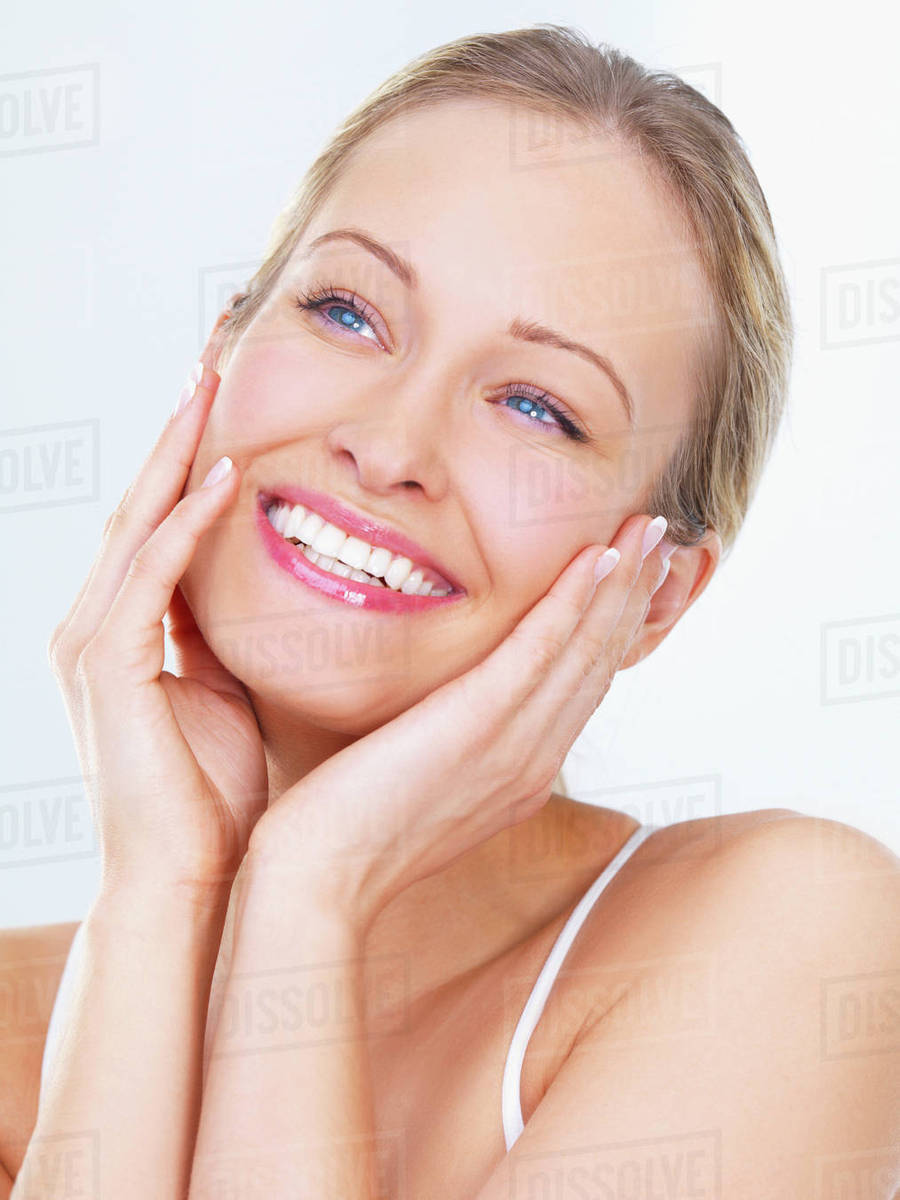 Woman with hands on cheeks - Stock Photo - Dissolve