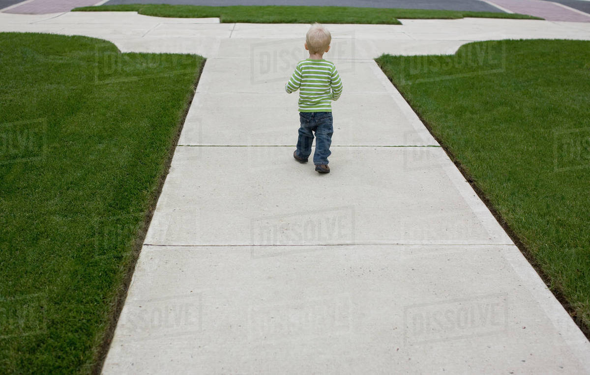 Baby boy walking on sidewalk - Royalty-free Stock Photo | Dissolve