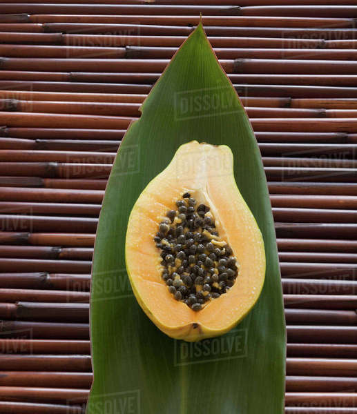 Close up of cut open fruit on leaf - Royalty-free Stock Photo | Dissolve