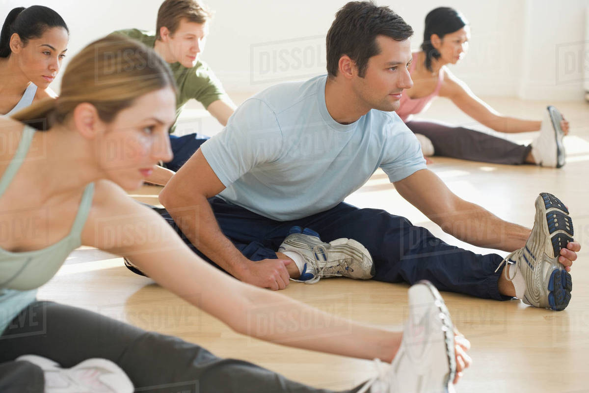Group of people stretching - Stock Photo - Dissolve