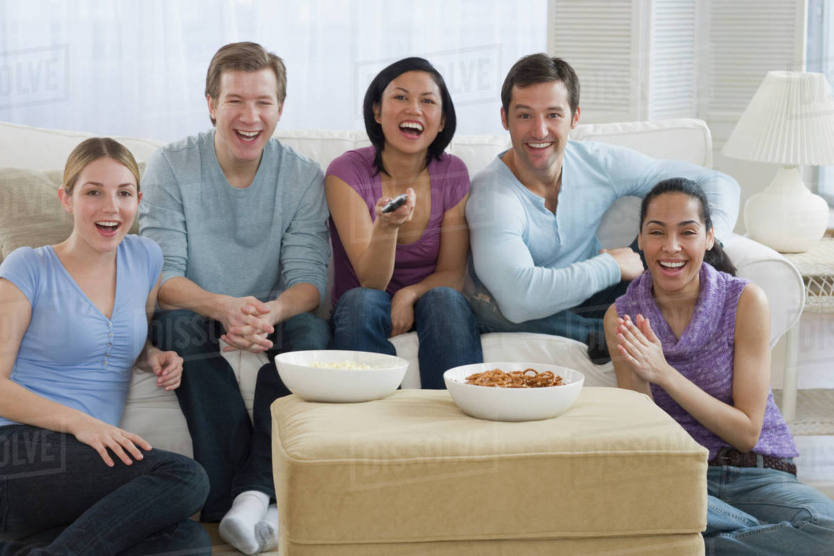 Group of friends watching television - Royalty-free Stock Photo | Dissolve