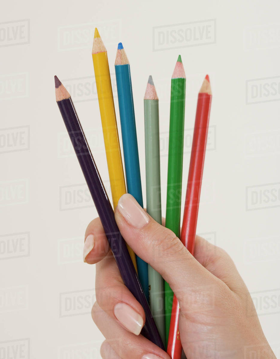 Close up of woman holding colored pencils - Royalty-free Stock Photo ...