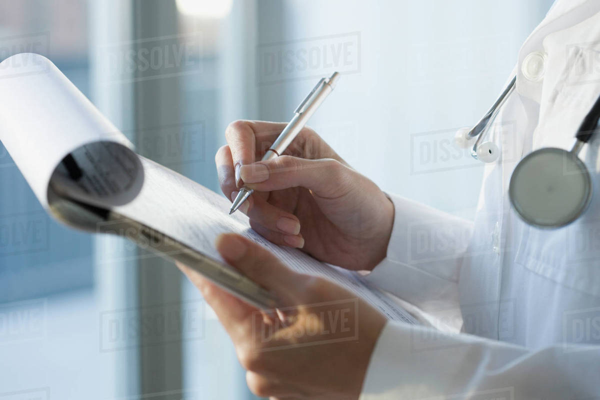 Close up of doctor writing on medical chart - Royalty-free Stock Photo ...
