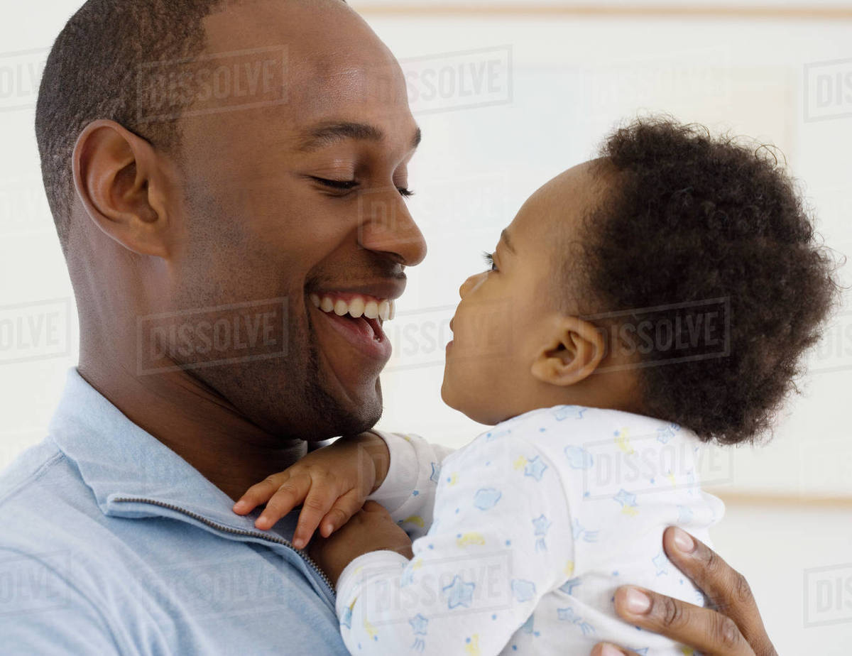 Father smiling at baby - Royalty-free Stock Photo | Dissolve