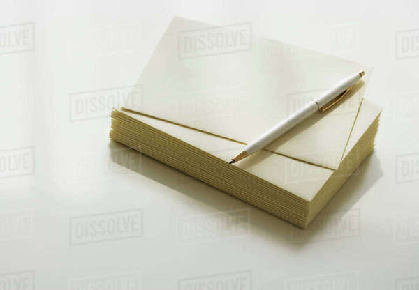Stack of note paper and pen - Royalty-free Stock Photo | Dissolve