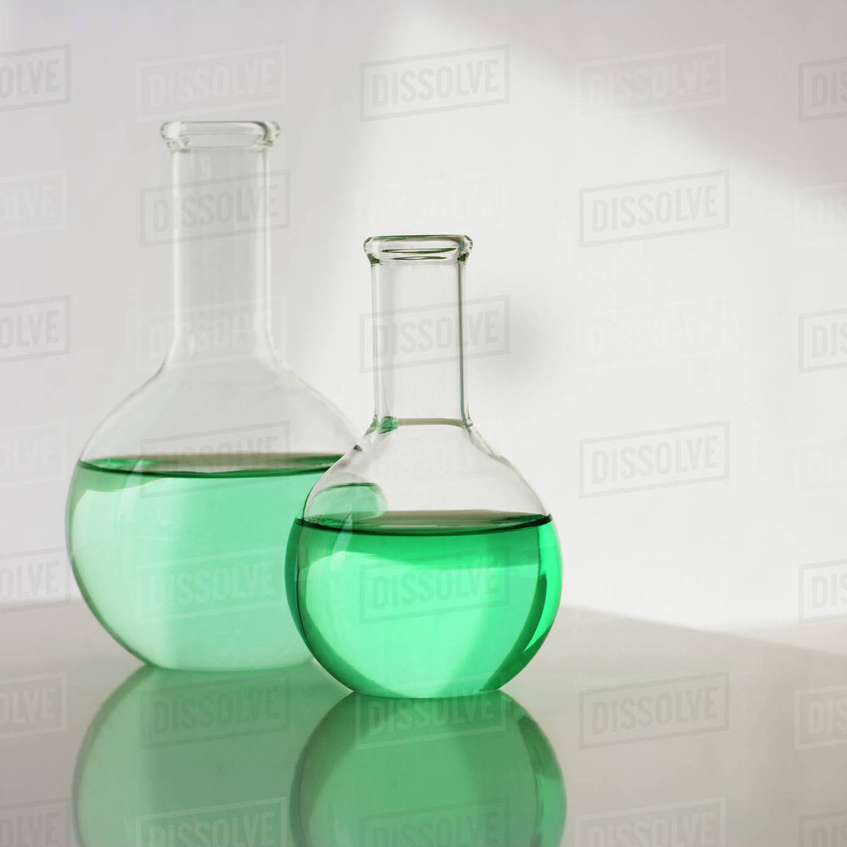 Two beakers with liquid - Stock Photo - Dissolve