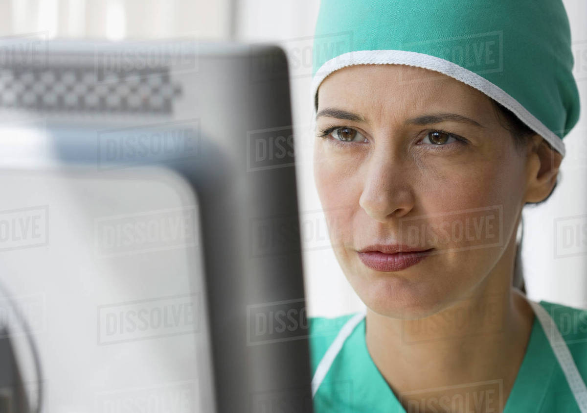 Female doctor looking at computer - Royalty-free Stock Photo | Dissolve