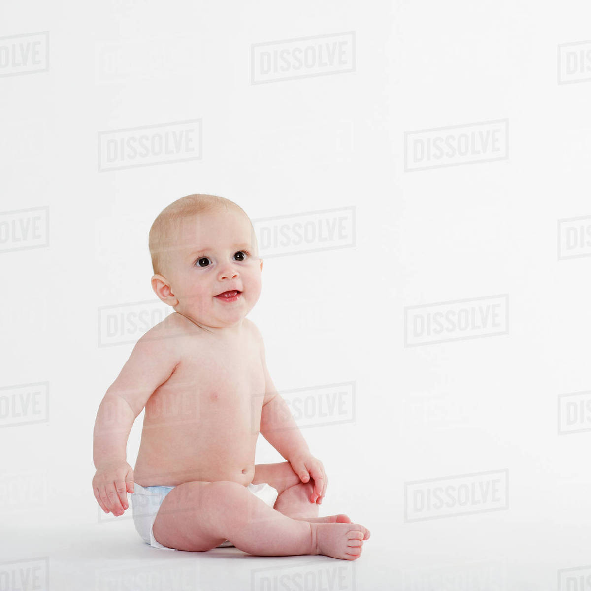 Studio shot of baby in diaper - Stock Photo - Dissolve