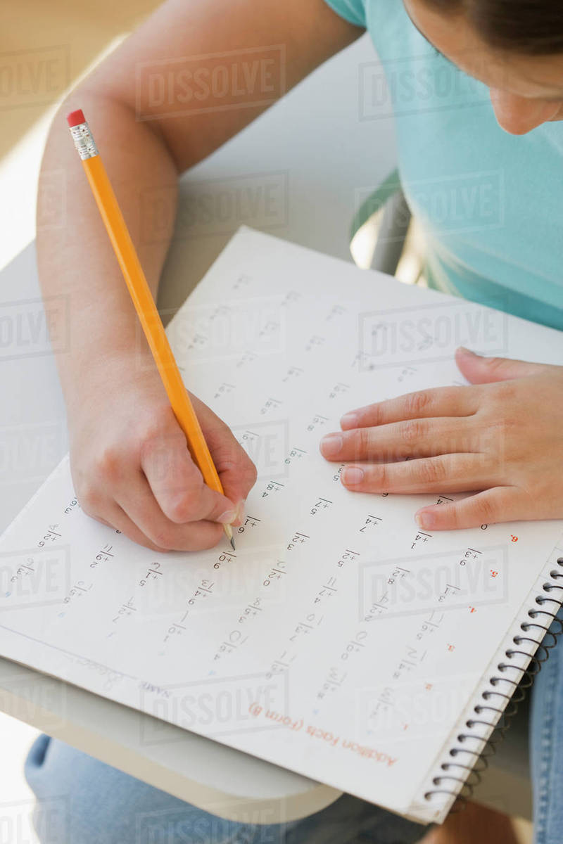 Girl writing in classroom - Royalty-free Stock Photo | Dissolve