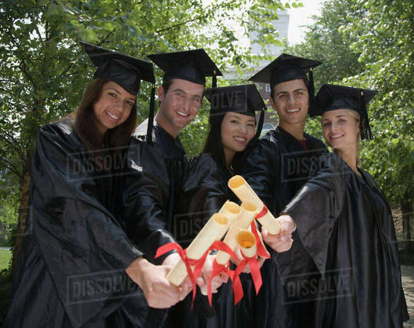 Group of college graduates holding diplomas - Stock Photo - Dissolve