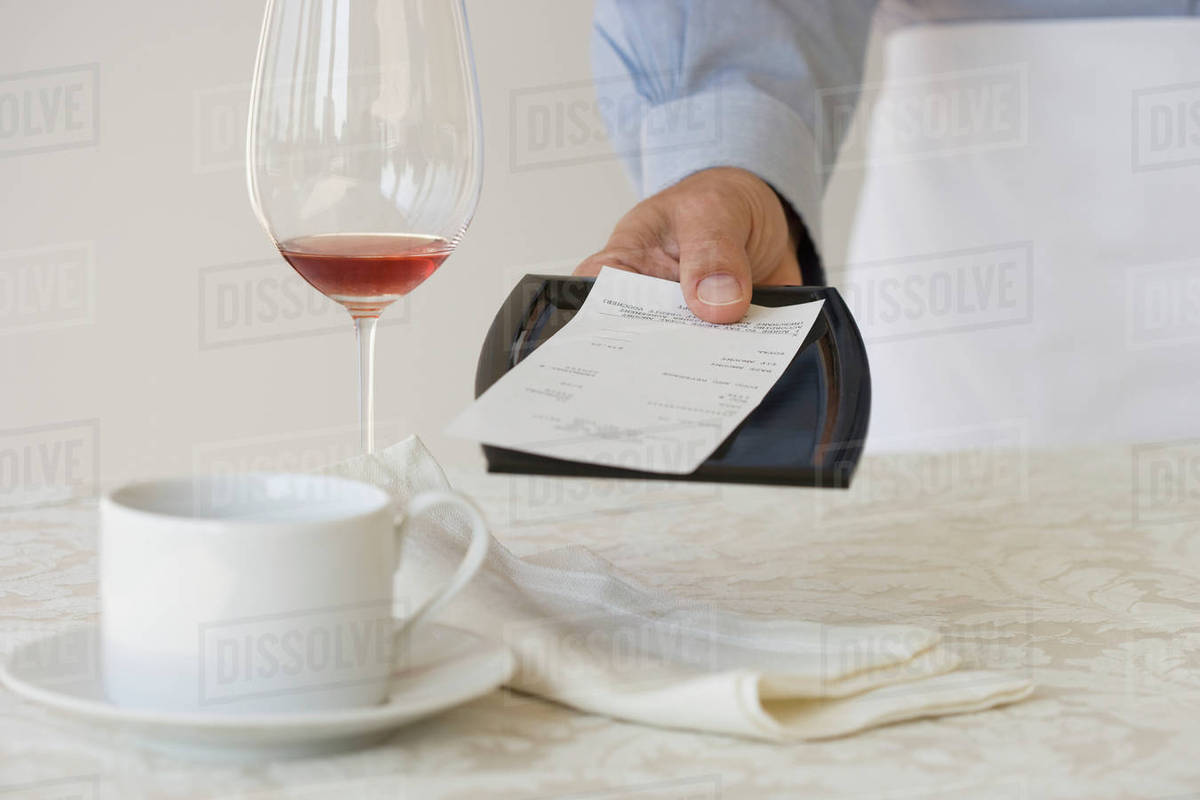 Waiter leaving check on table - Royalty-free Stock Photo | Dissolve