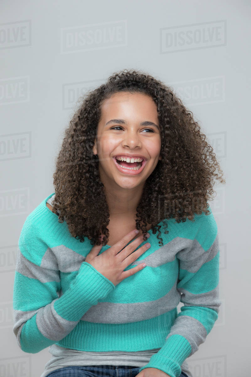 Portrait of girl (12-13) laughing - Royalty-free Stock Photo | Dissolve