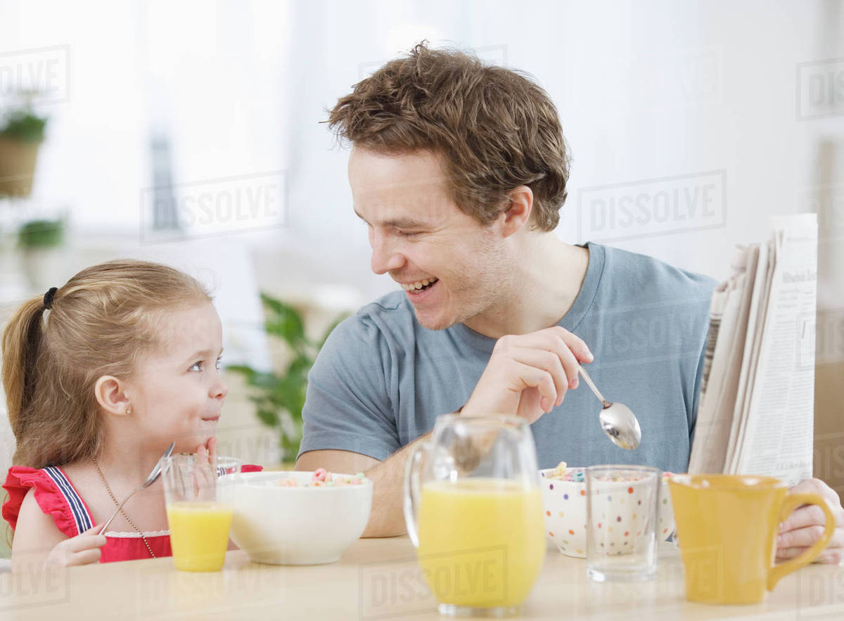 Father and daughter eating breakfast - Royalty-free Stock Photo | Dissolve