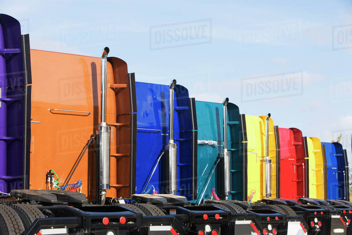 Rear view of row of tractor trailer cabs - Royalty-free Stock Photo ...
