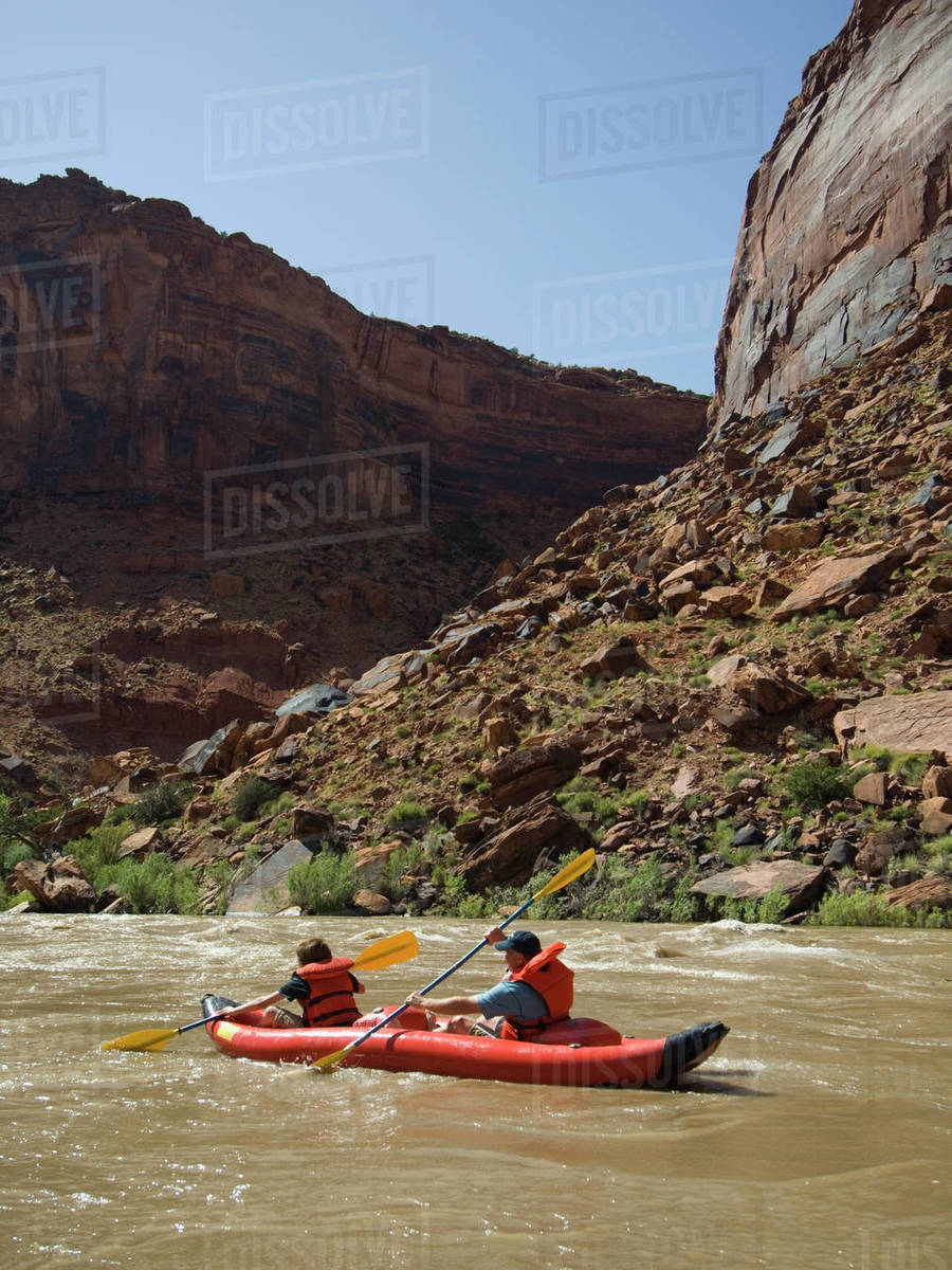 People paddling in raft - Stock Photo - Dissolve