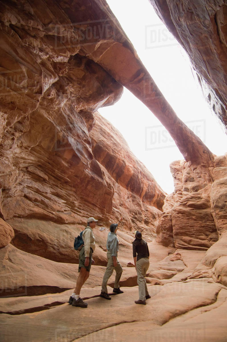 People looking up at rock formations - Stock Photo - Dissolve