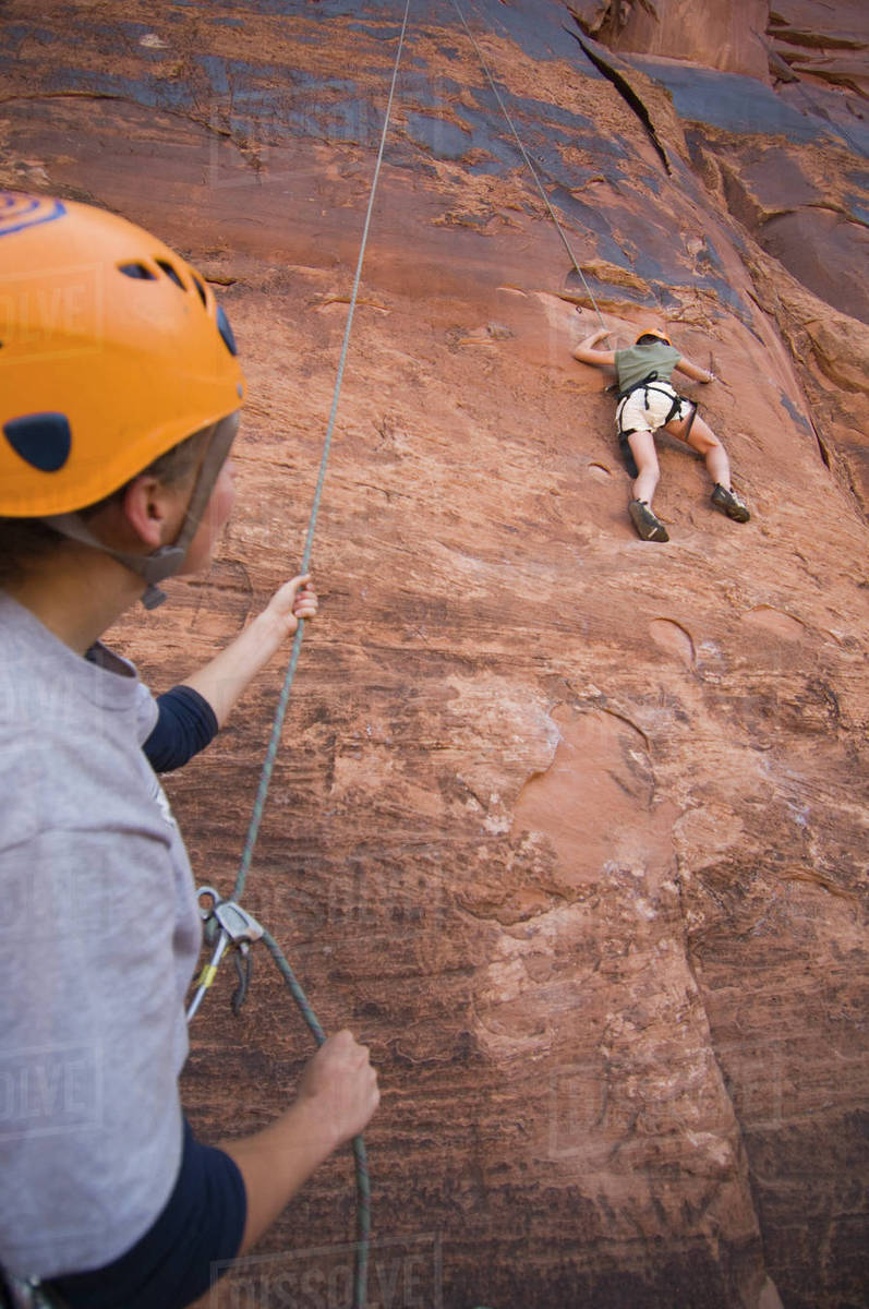 Two people rock climbing - Stock Photo - Dissolve