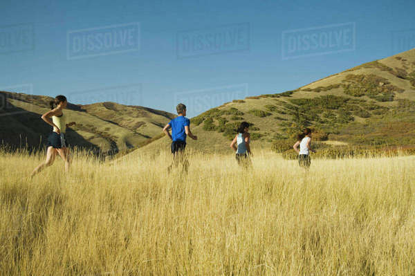 Group of people running in field, Utah, United States - Royalty-free ...