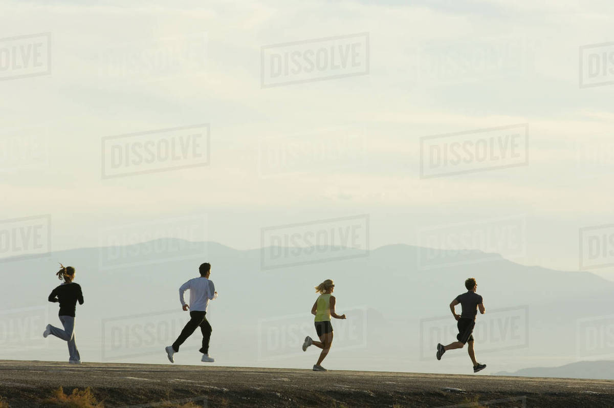 Group of people running on road, Utah, United States - Stock Photo ...