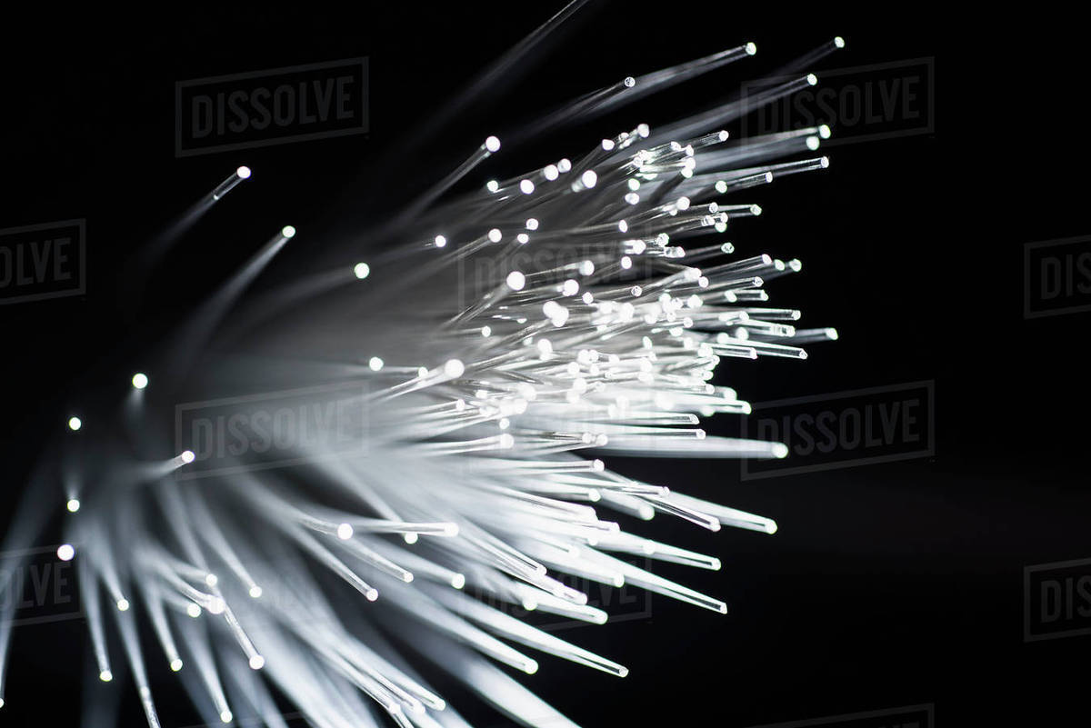 Bunch of glowing fiber optic cables on black background - Royalty-free ...