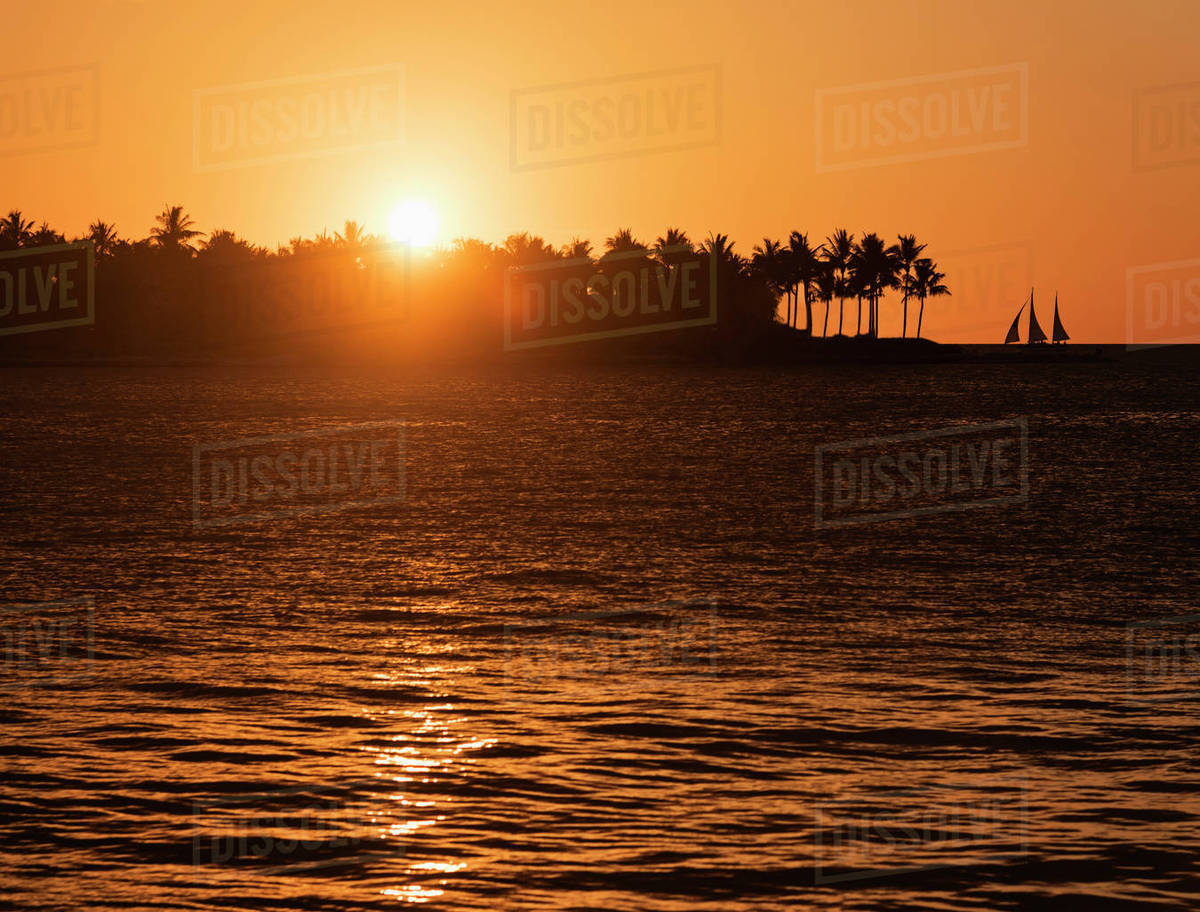 Sunset over island - Royalty-free Stock Photo | Dissolve