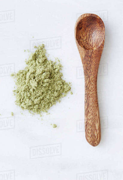 Overhead view of wooden spoon and green powder - Royalty-free Stock ...