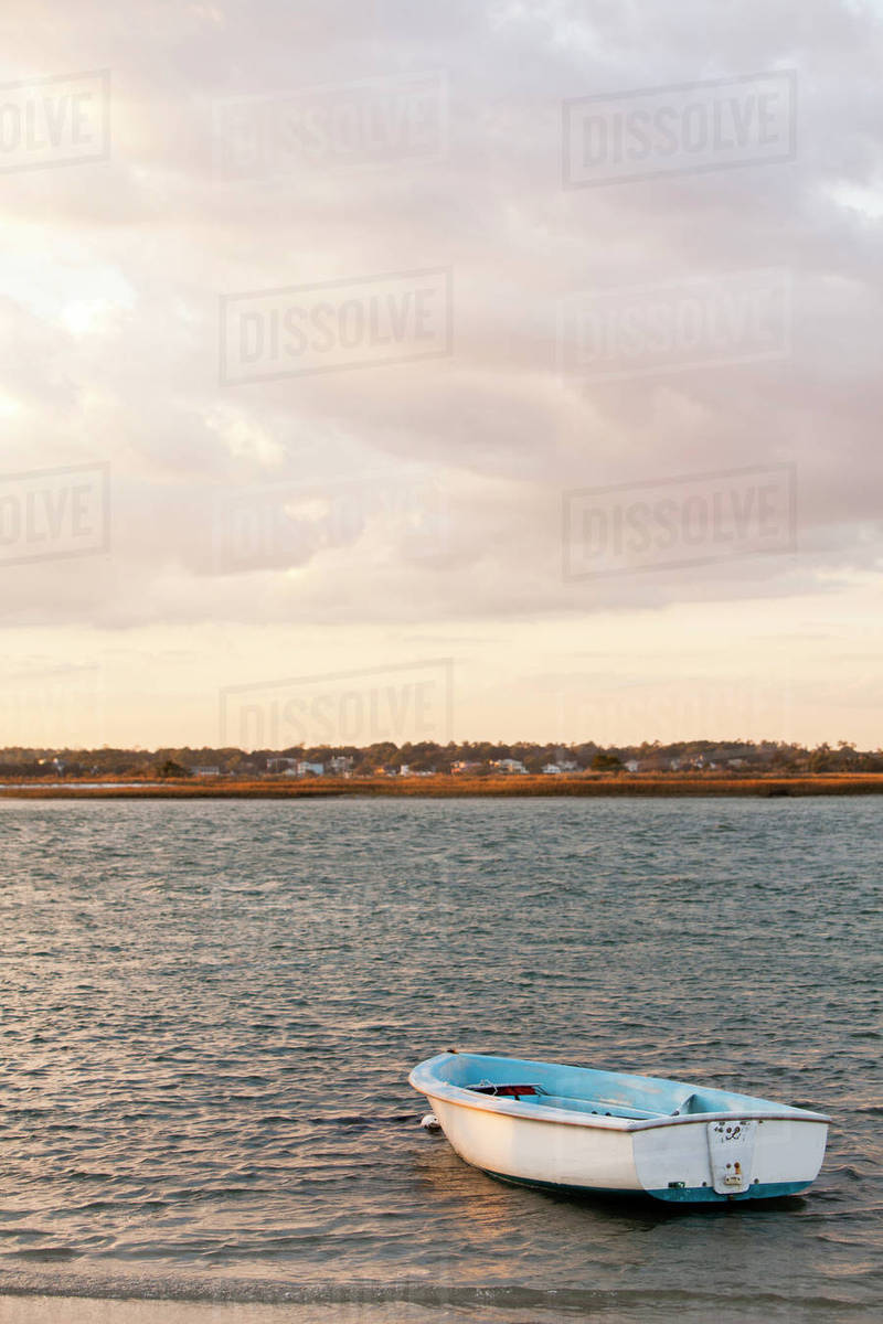 Empty boat in water - Royalty-free Stock Photo | Dissolve