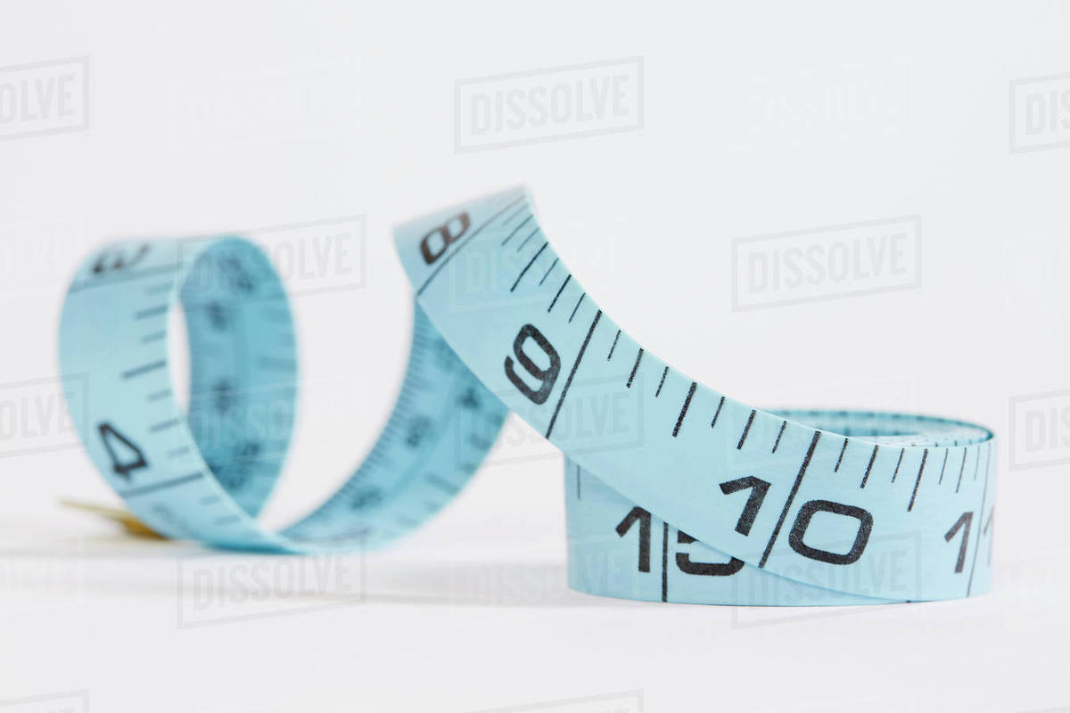 Blue measuring tape on white background - Stock Photo - Dissolve