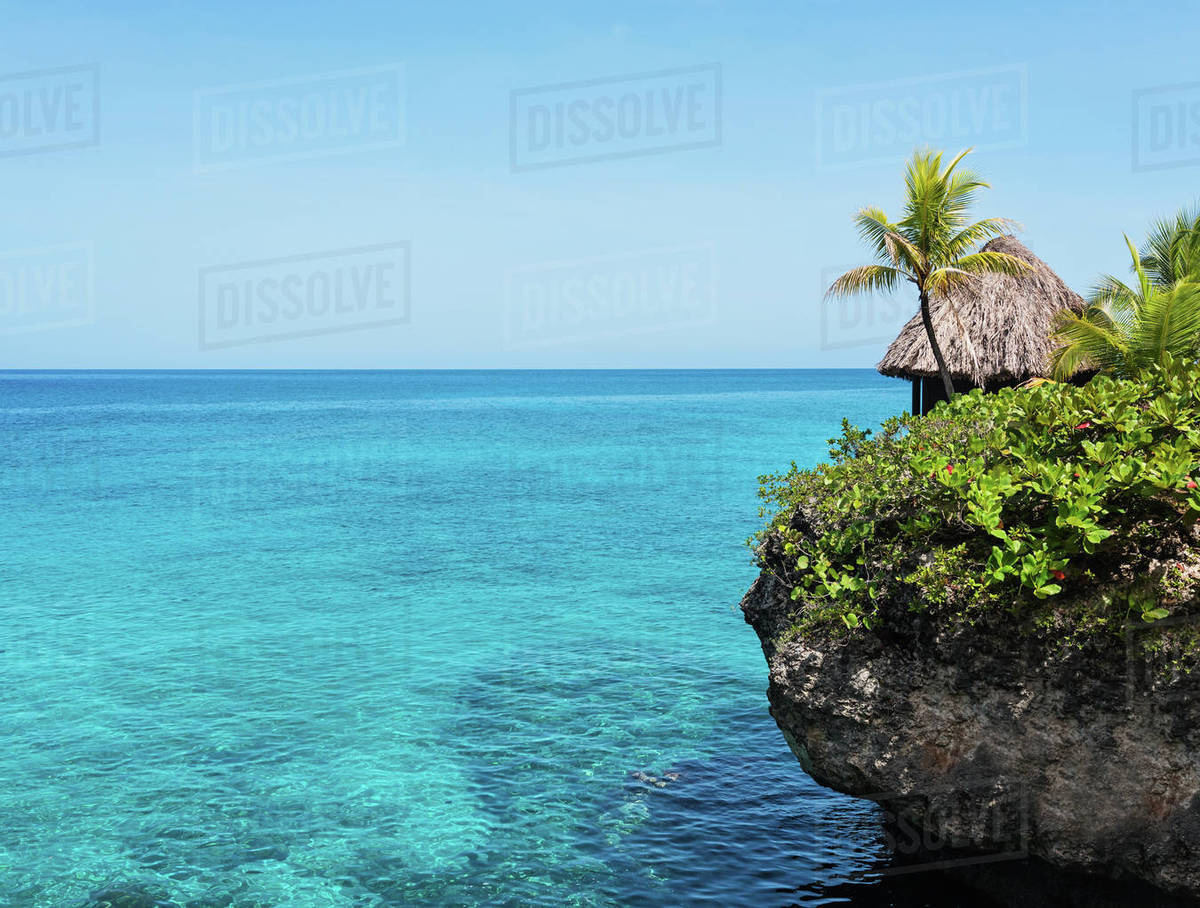 Jamaica, Negril, Traditional huts on rocky coastline - Royalty-free ...