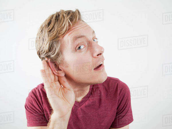 Man cupping his ear with his hand - Royalty-free Stock Photo | Dissolve
