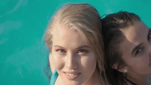 Top view video of two sexy women in swimsuit posing in outdoor swimming ...