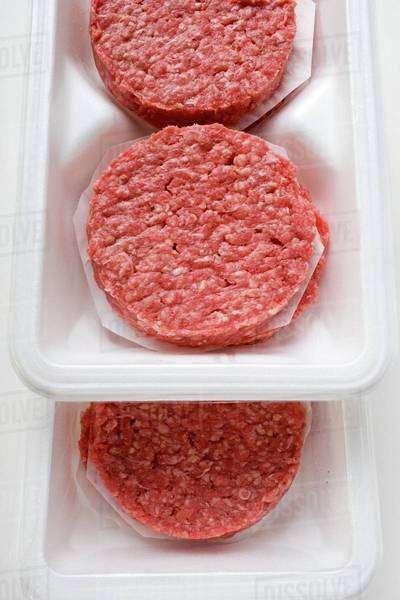 Raw burgers for hamburgers in packaging - Stock Photo - Dissolve