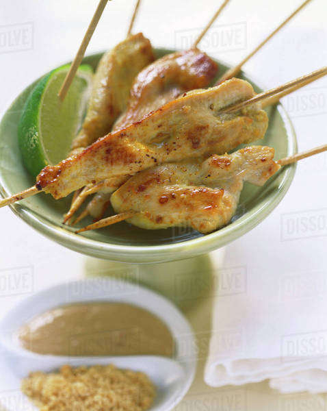 Chicken sate with peanut sauce - Stock Photo - Dissolve