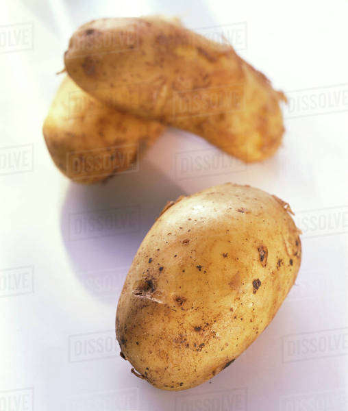 Three Italian Spunta potatoes - Royalty-free Stock Photo | Dissolve