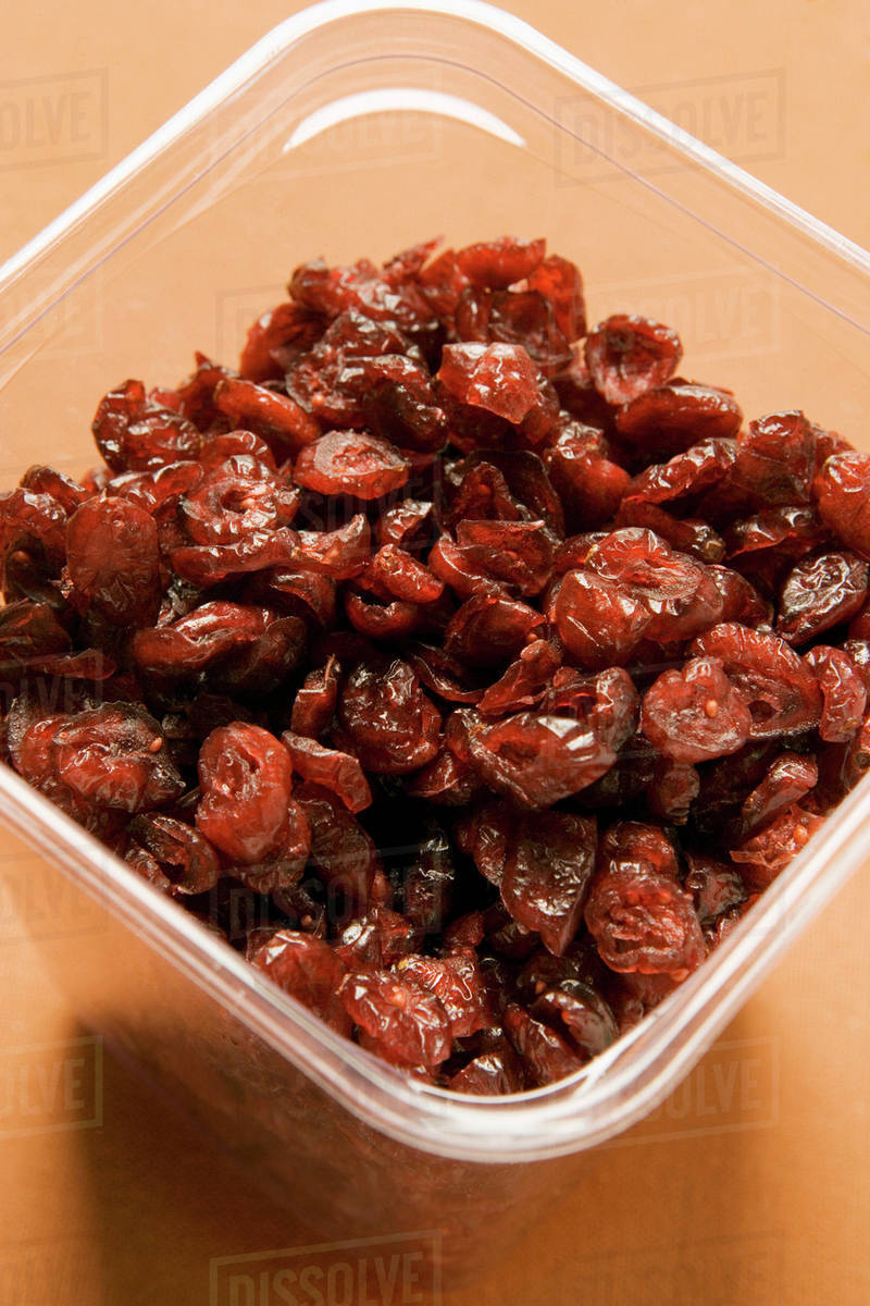 Dried cranberries in plastic container - Stock Photo - Dissolve