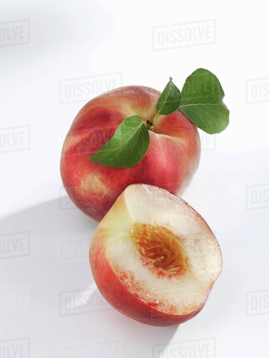 White-flesh peaches, whole and halved - Royalty-free Stock Photo | Dissolve